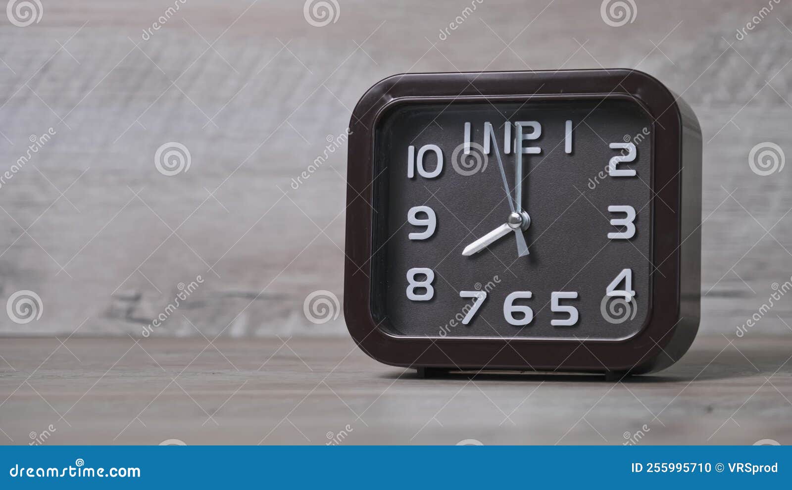 The Pointer Clock on a Wooden Table Shows the Time Stock Footage ...