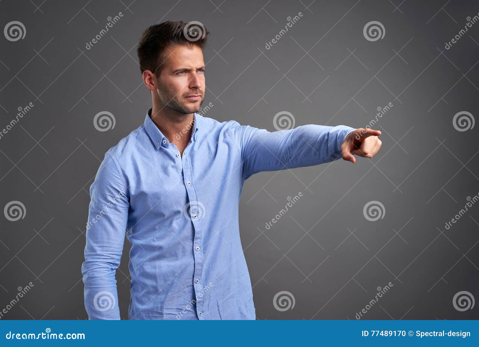 Pointing young man stock photo. Image of expressing, emotion - 77489170