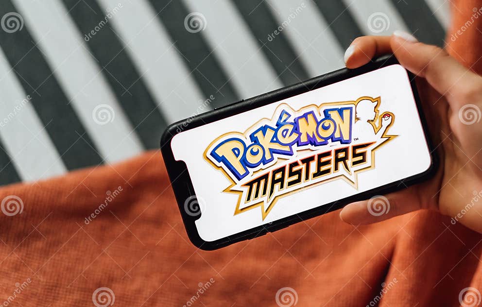 Hands Holding IPhone with Pokemon Masters on the Screen. Editorial ...