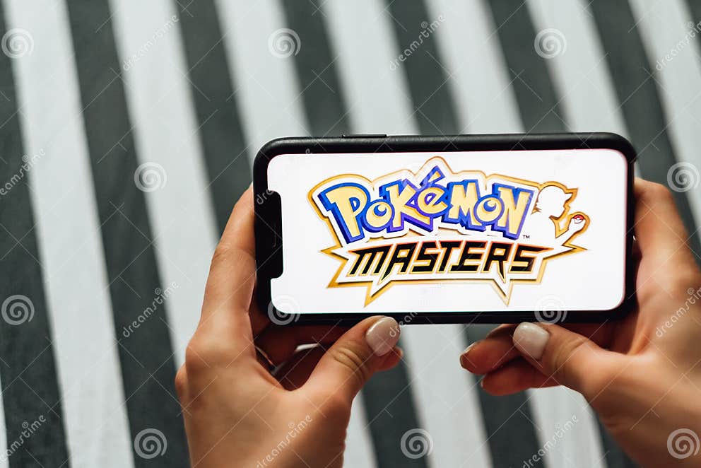 Hands Holding IPhone with Pokemon Masters on the Screen. Editorial ...