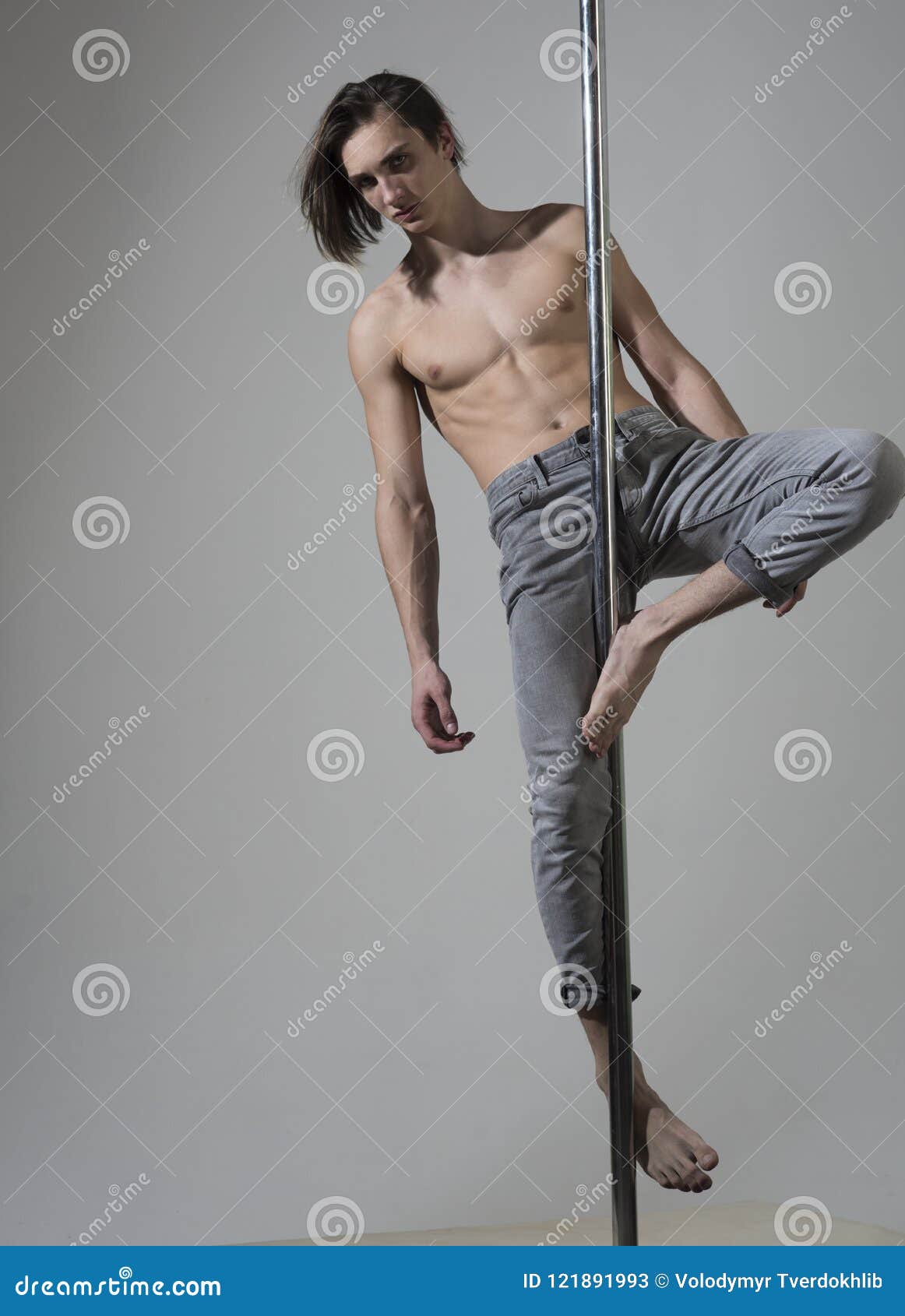 Pole Dance Trainer. Young Man Training on Pylon in Grey Studio Stock ...