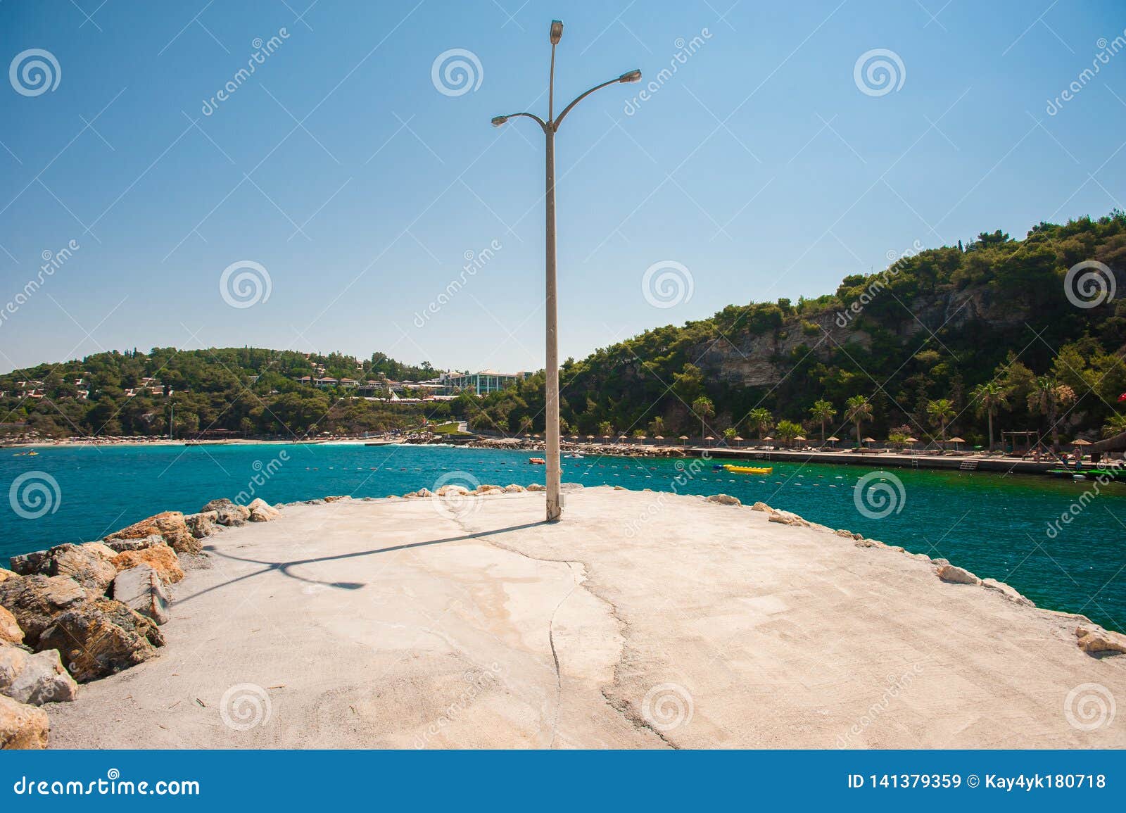 A Pole with a Lantern on the Beach Backlit by the Sea Stock Image ...