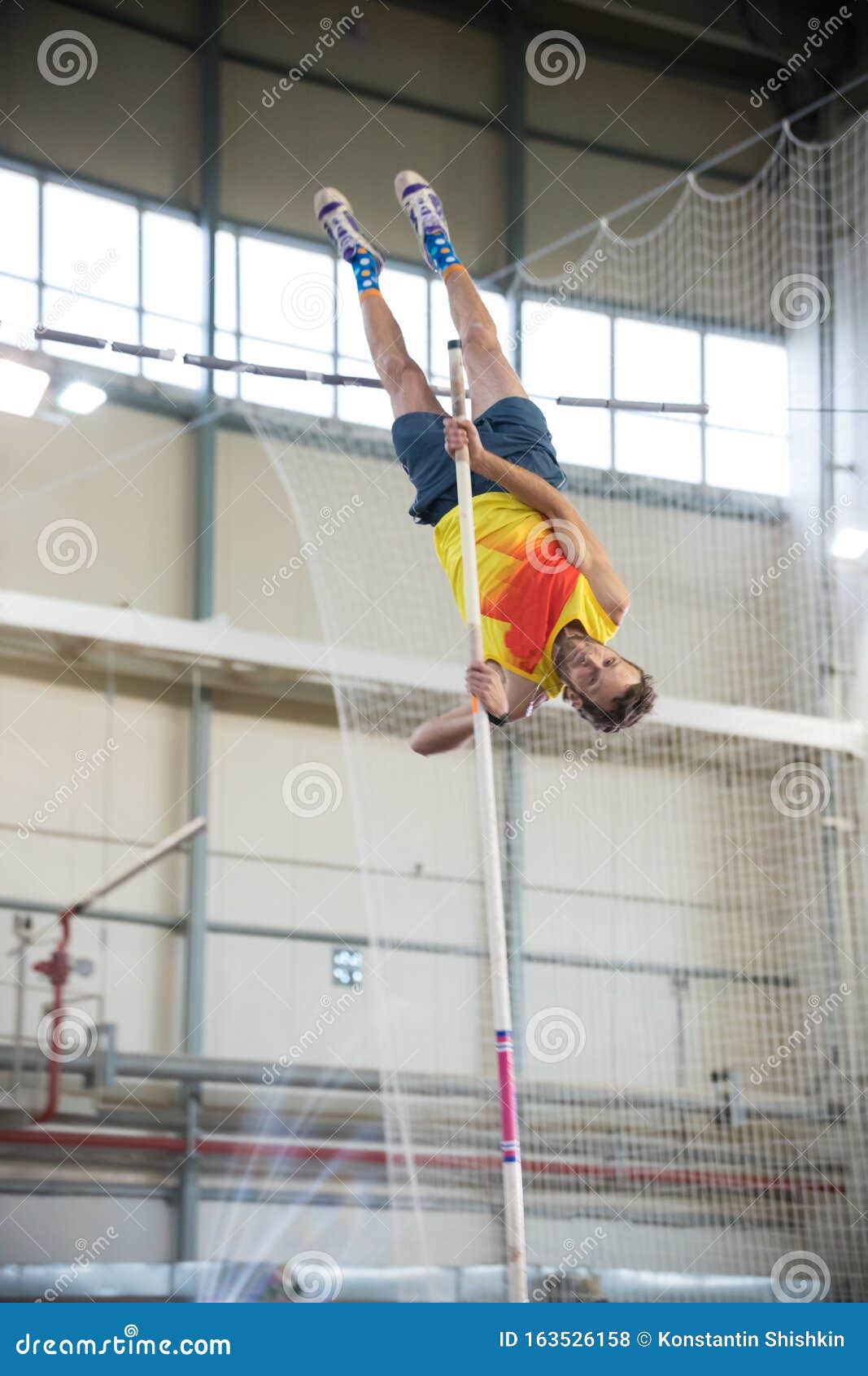 Pole Vaulting - Man with Beard is Reaching the Bar on the Pole Stock ...