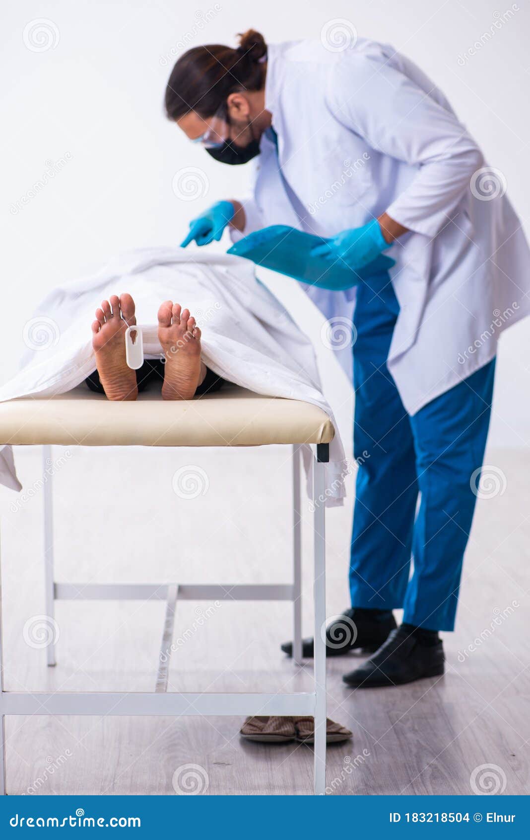 Police Coroner Examining Dead Body Corpse in Morgue Stock Photo - Image ...