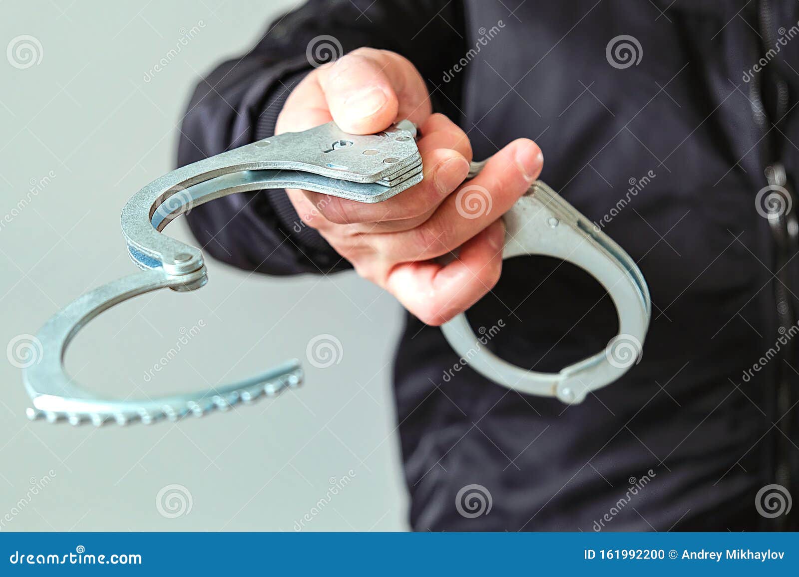 Police Detective. Handcuffs in Hand. Arrest of the Criminal. Stock ...
