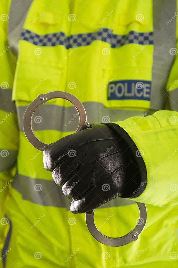 Police Officer Holding Handcuffs Stock Photo - Image of copper ...