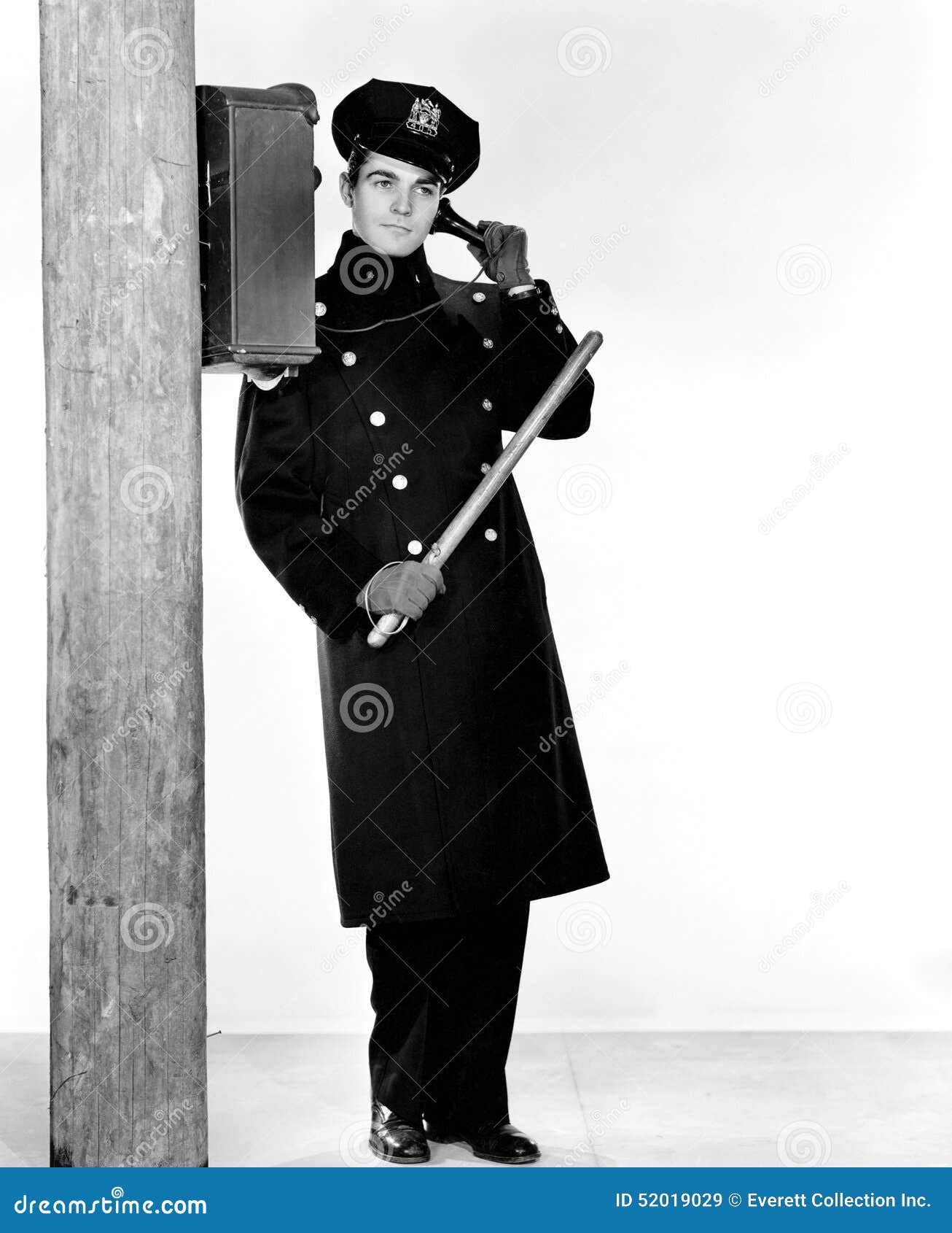 Police Officer Holding a Nightstick and Talking on a Phone Stock Image ...
