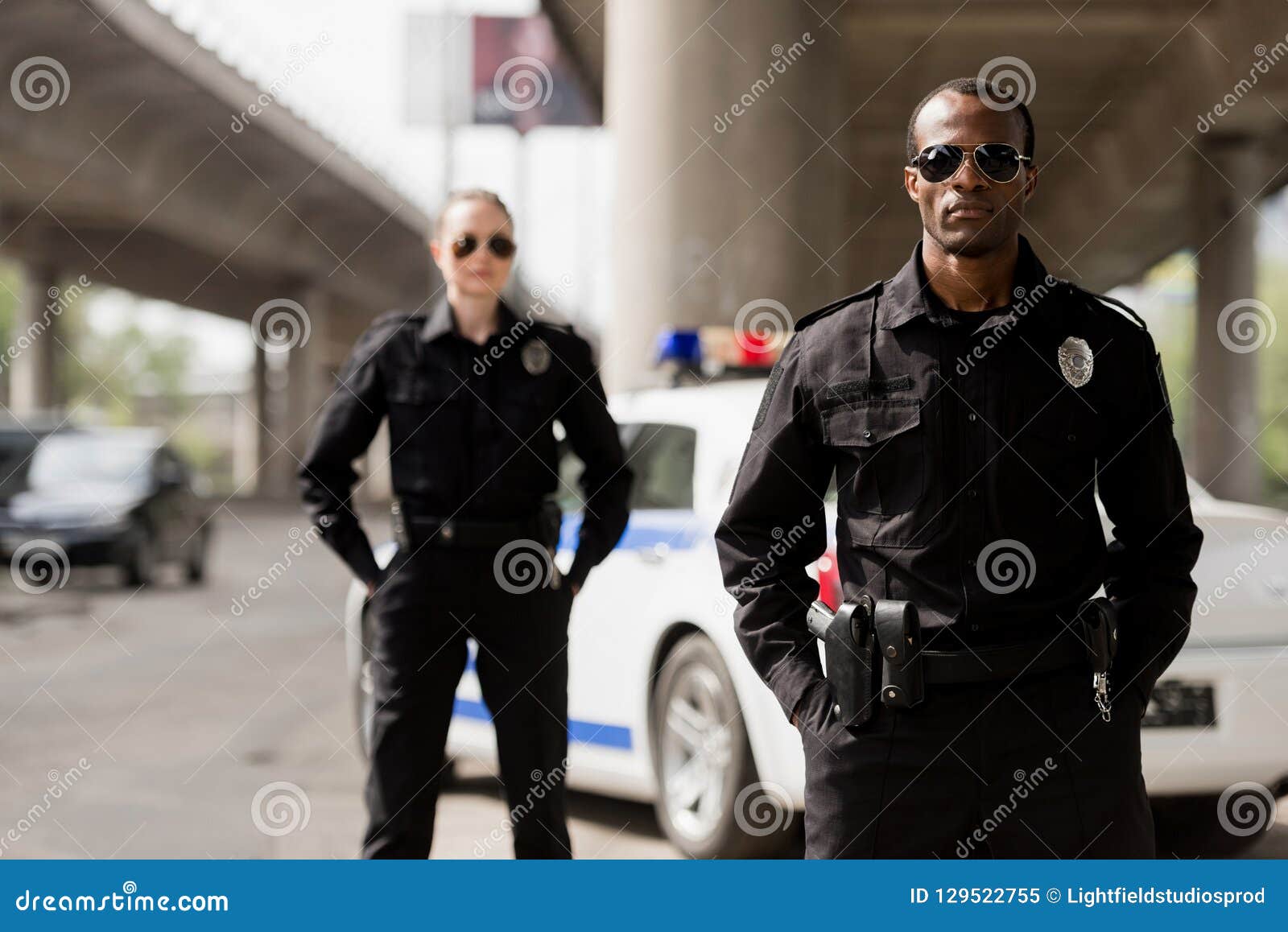 Police Officers with Hands in Pockets Looking at Camera in Front Stock ...