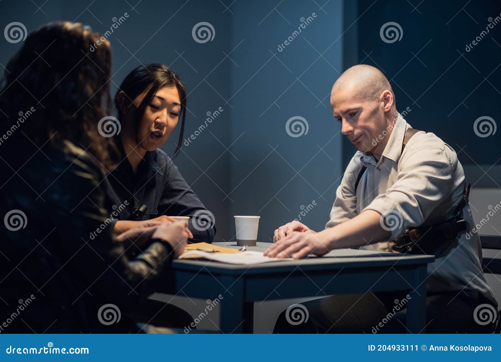 At the Police Station, Two Officers are Interrogating the Captured ...