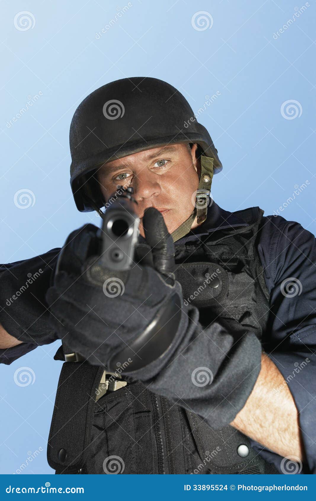 Policeman Aiming Gun Against Blue Sky Stock Images - Image: 33895524