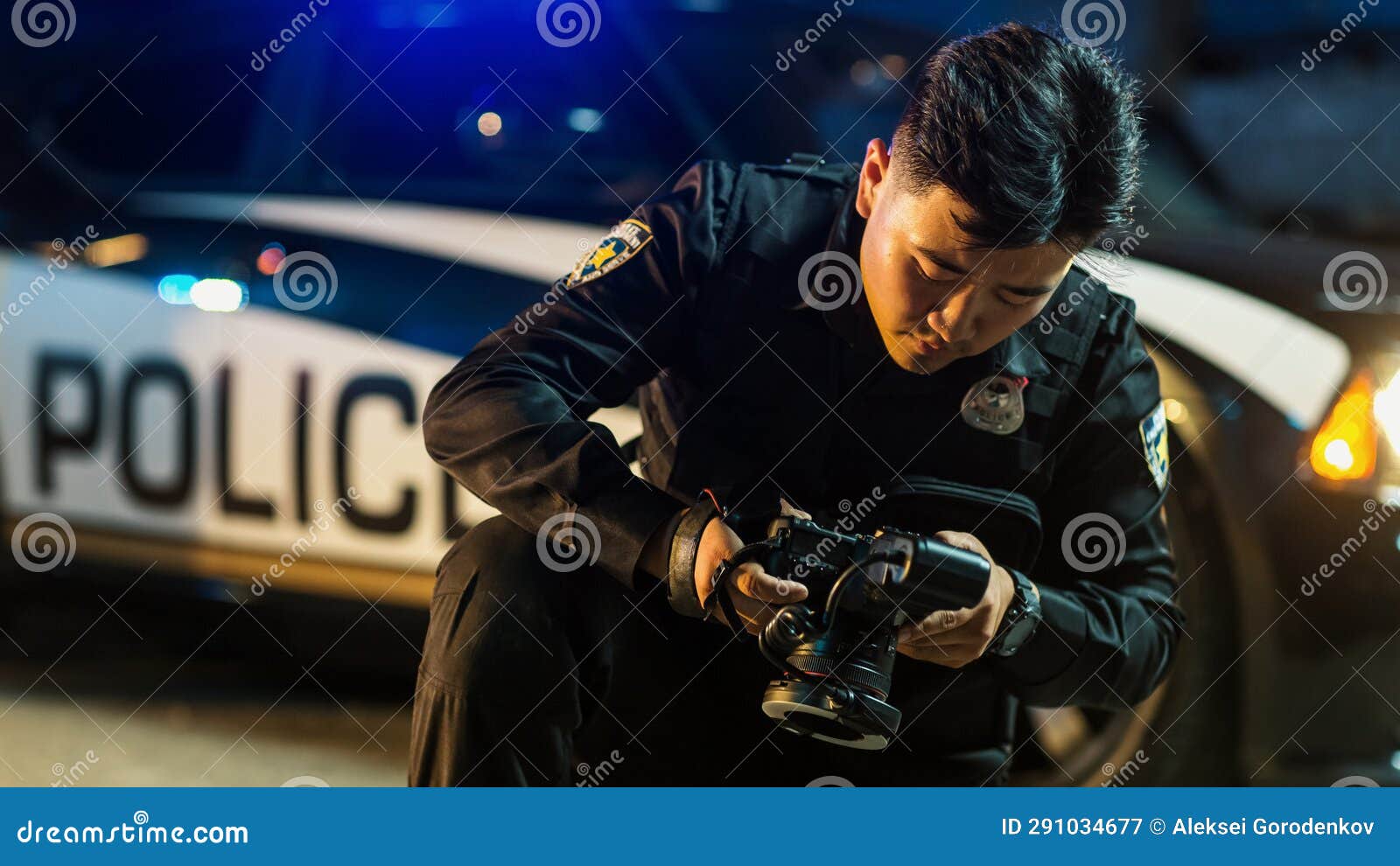 Policeman Checking Camera after Taking Forensic Photos of Evidence ...