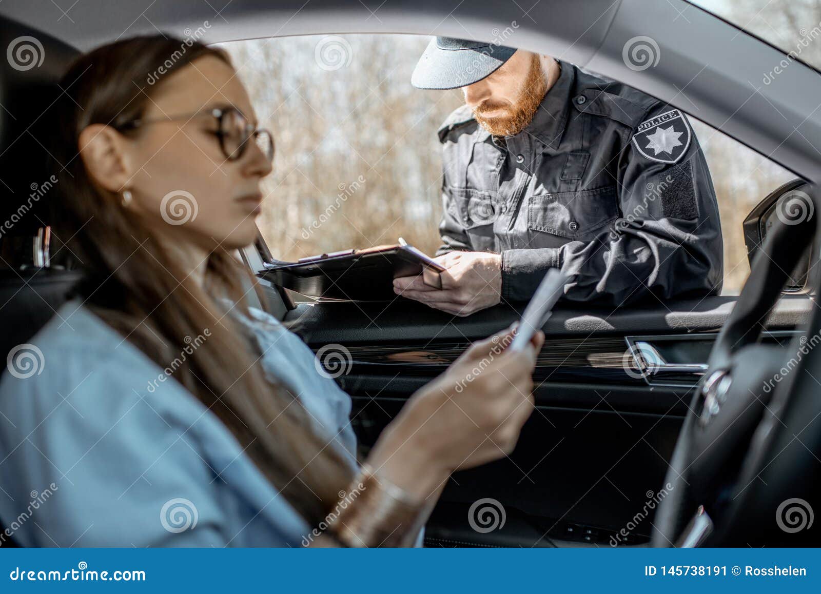 Policeman Checking Documents of a Female Driver Stock Image - Image of ...