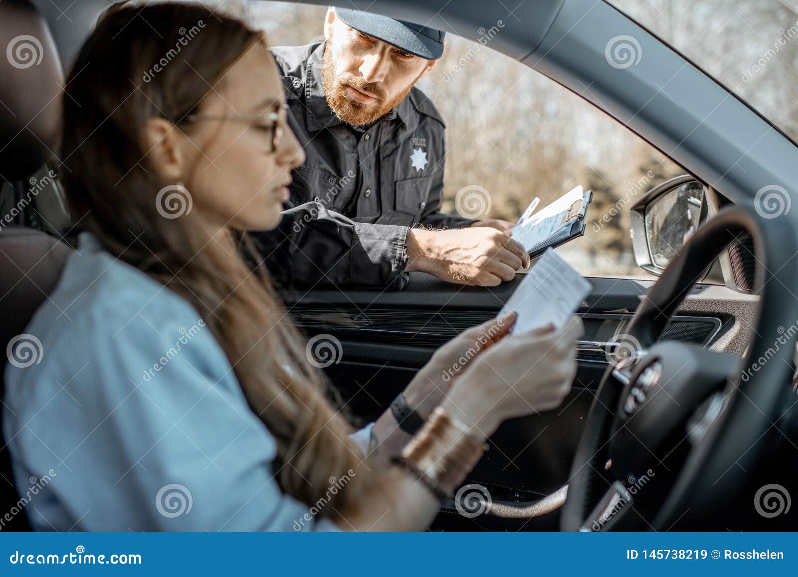 Policeman Checking Documents of a Female Driver Stock Image - Image of ...