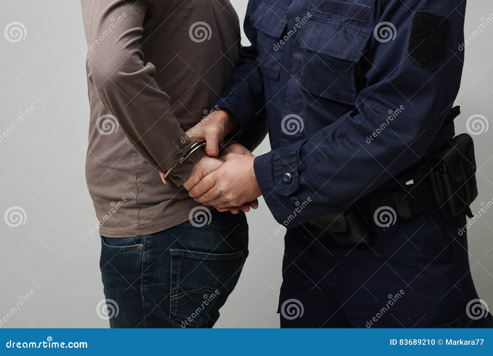Policeman Handcuffing an Illigal Man. Stock Photo - Image of security ...