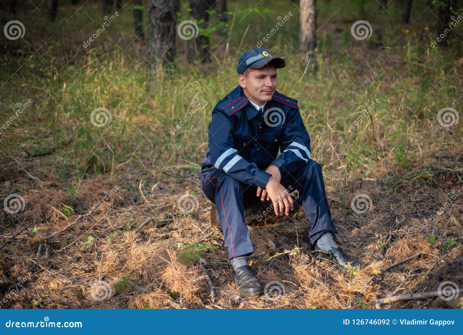 Policeman Sits on the Grass in the Forest and Thinks Stock Photo ...