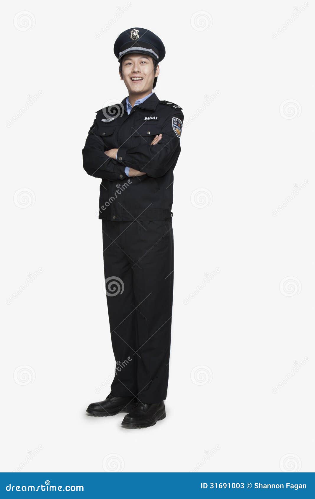 Policeman Standing and Smiling Stock Image - Image of full, crossed ...