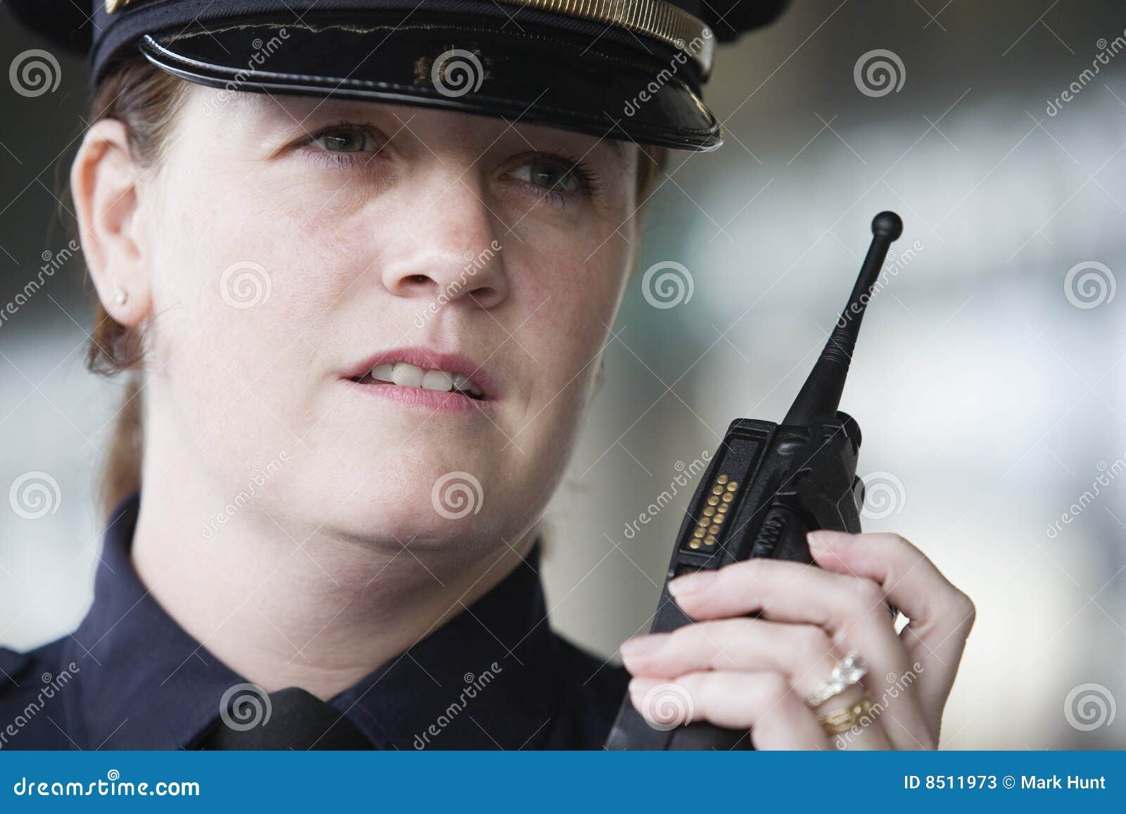 Policewoman Communicating Over Her Radio. Stock Image - Image of ...