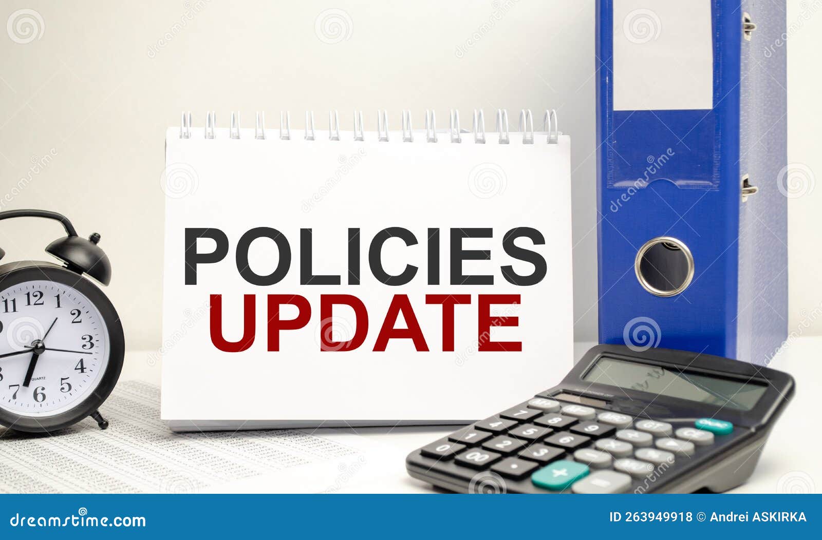 Policies Update Words on White Notebook with Clock, Calculator and ...