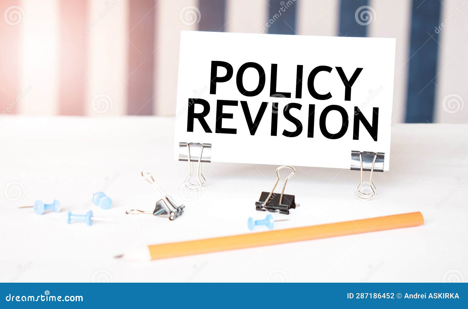 Policy Revision Sign on Paper on White Desk with Office Tools. Blue and ...