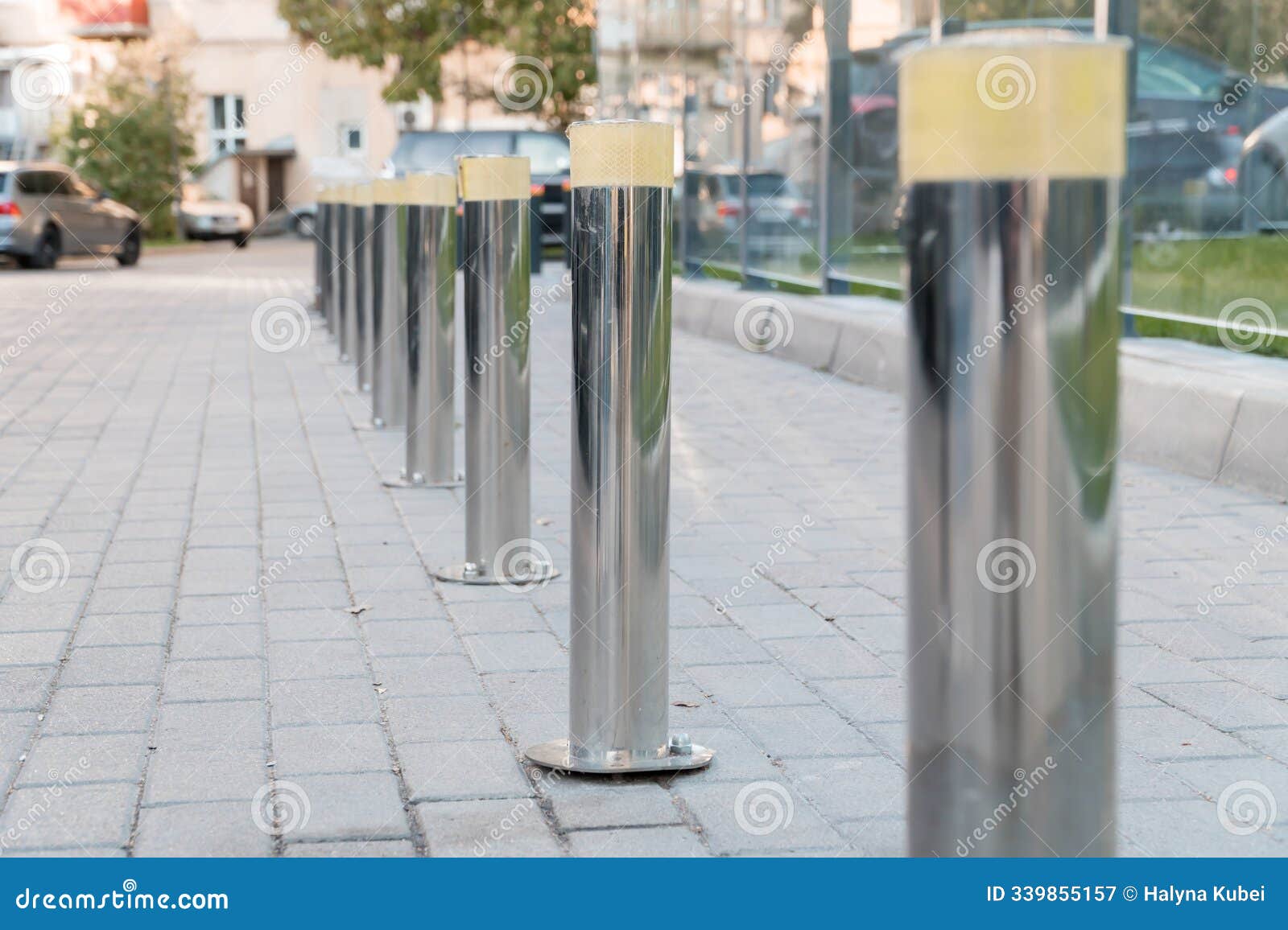 Polished Silver Bollards Line a Paved Pathway in Urban Setting Stock ...