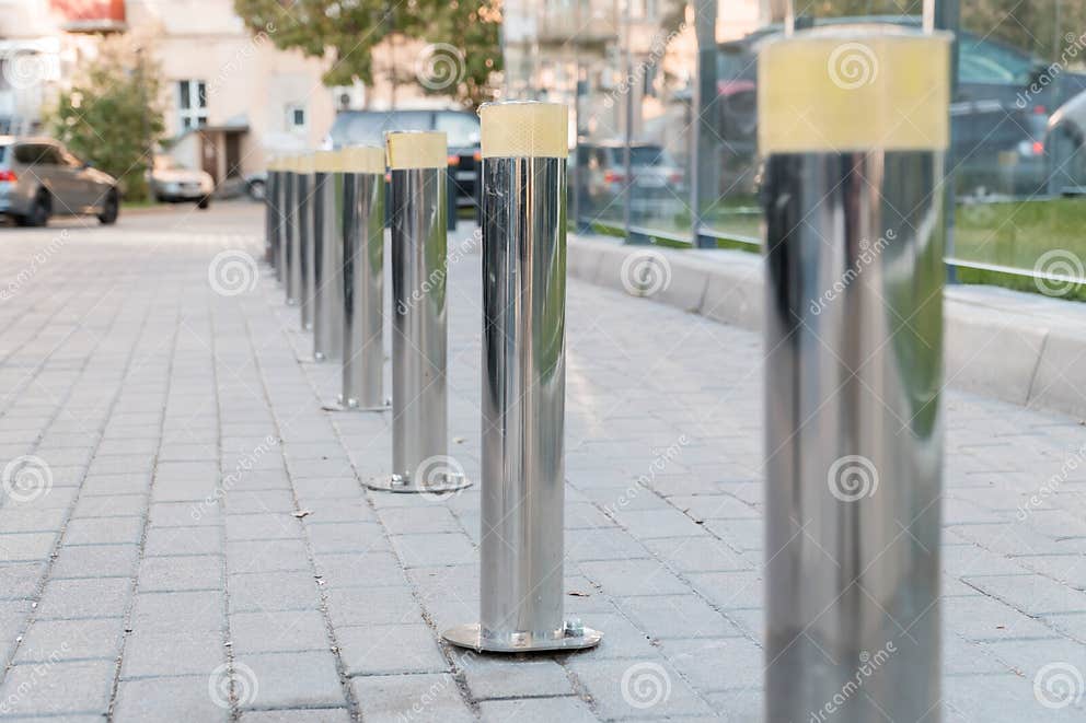 Polished Silver Bollards Line a Paved Pathway in Urban Setting Stock ...