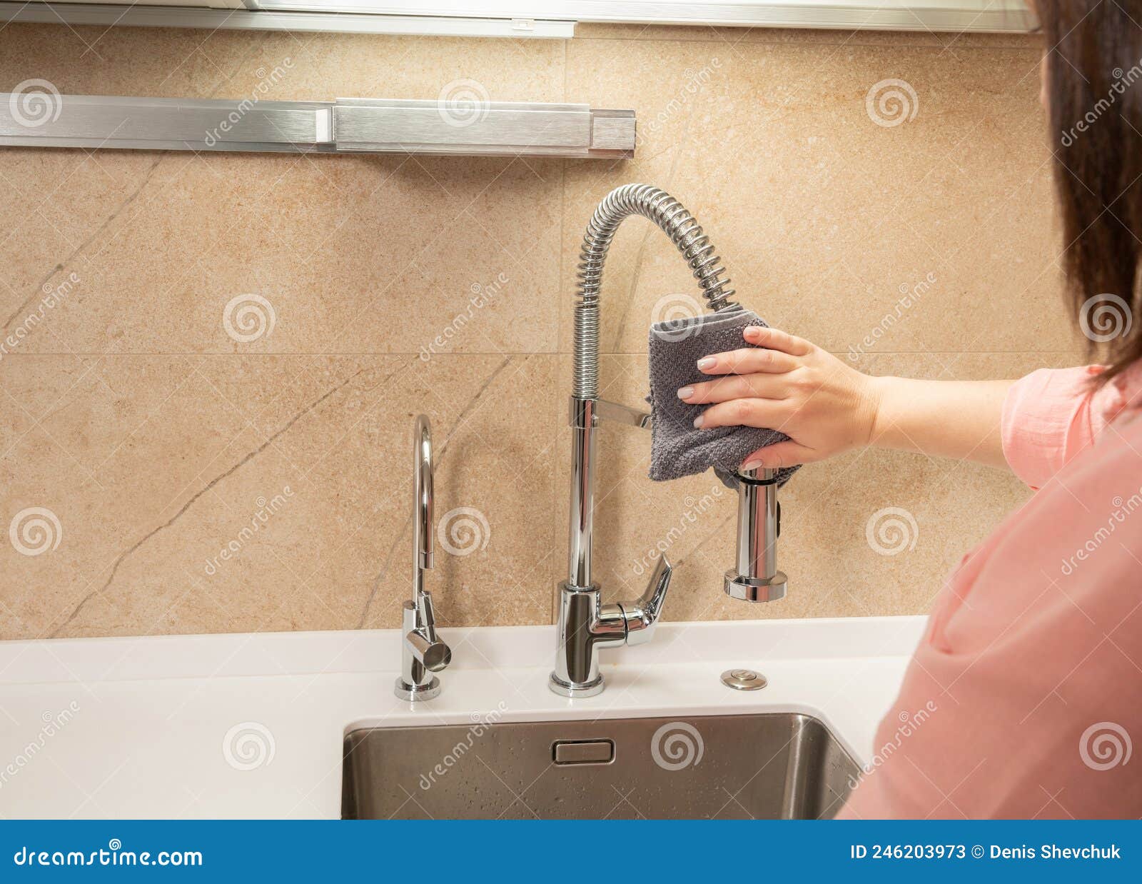Polishing Metal Surfaces with a Rag in the Kitchen Stock Image - Image ...