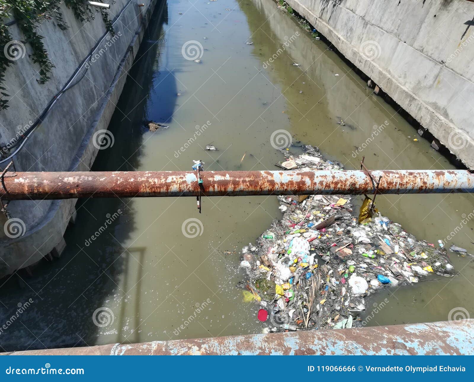 Polluted Water and Floating Garbage Flowing in the River Under the ...