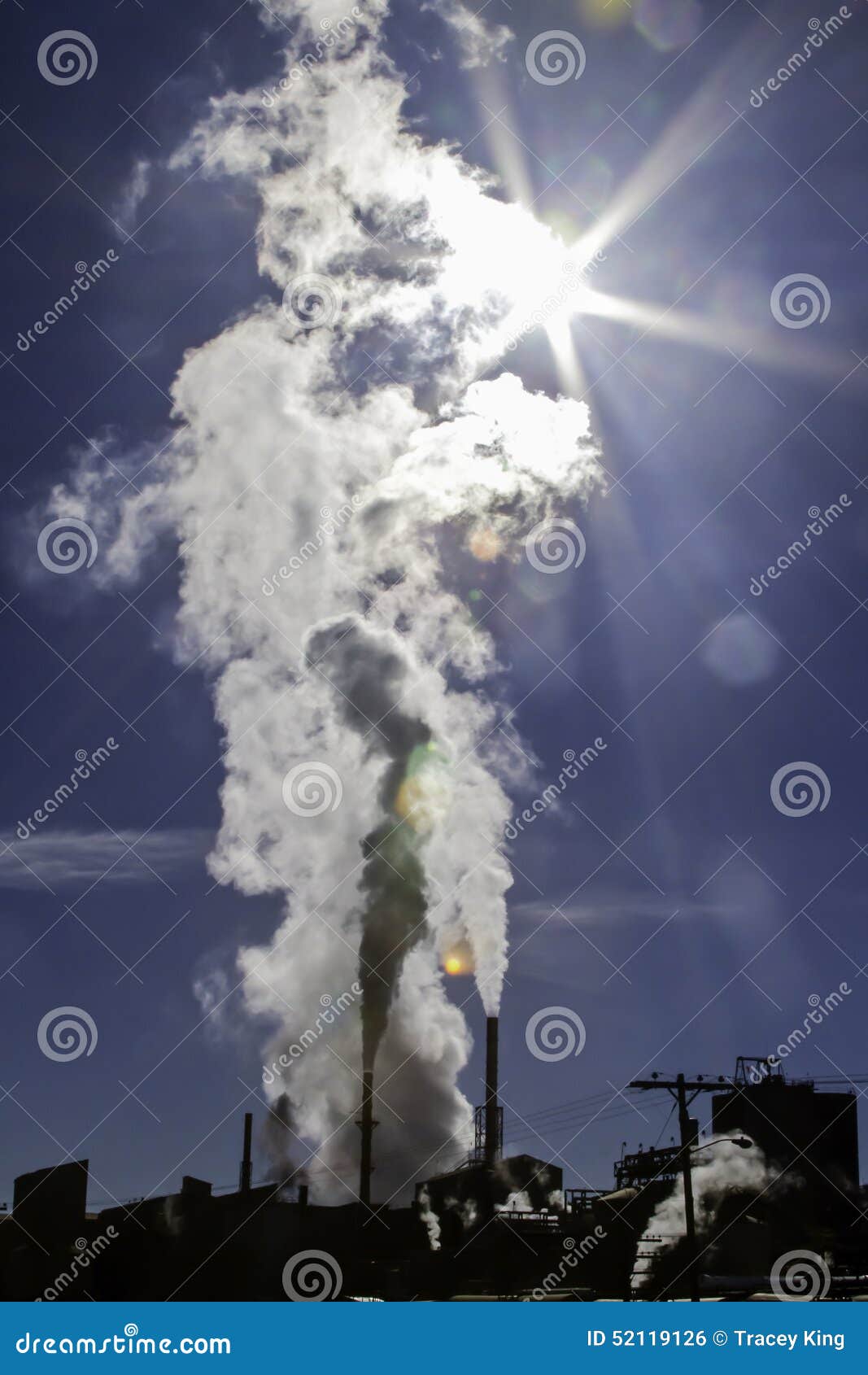 Pollution Rises into the Blue Sky in Front of a Sun Star Stock Photo ...