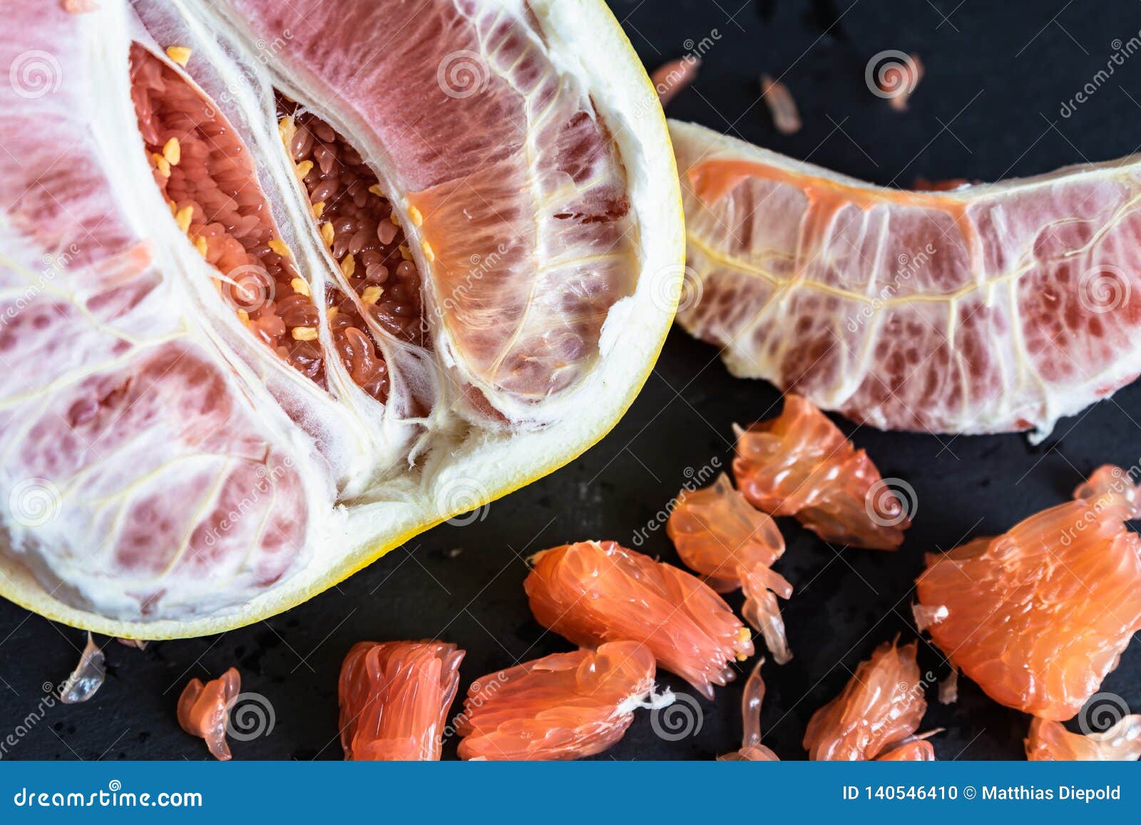 Pomelo with Red Pulp in Front of Dark Background Stock Photo - Image of ...