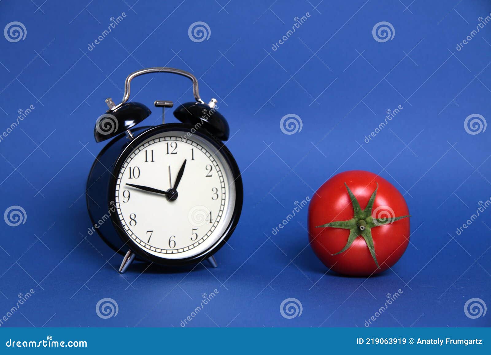 Pomodoro Technique Concept - Tomato and Alarm Clock on Blue Background ...