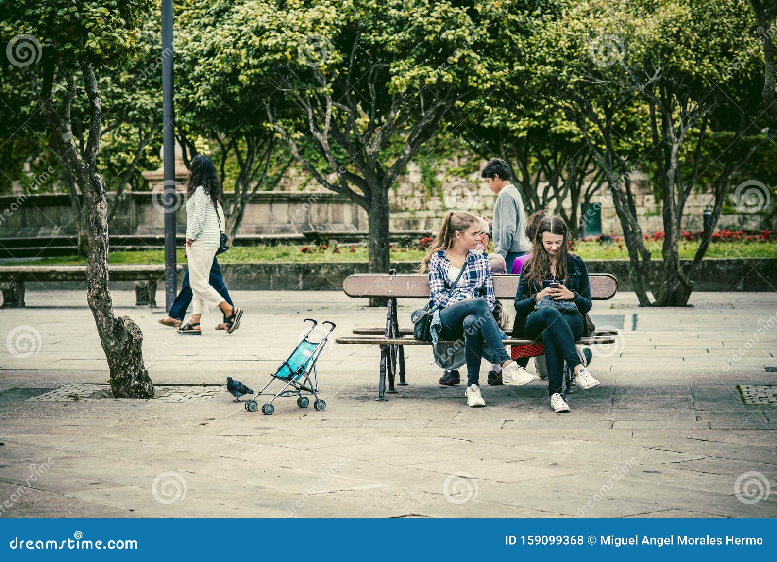 Two Young Women, Sitting on a Bench Editorial Stock Photo - Image of ... Two Young Women, Sitting on a Bench Editorial Stock Photo - Image of ...