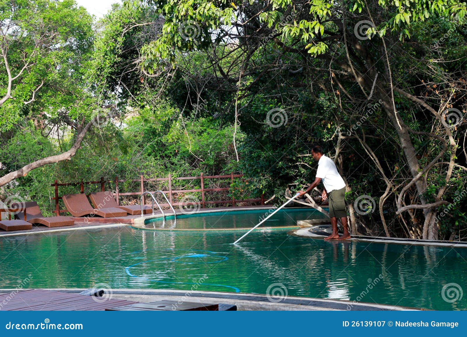 Pool cleaning in hotel stock image. Image of pool, male - 26139107