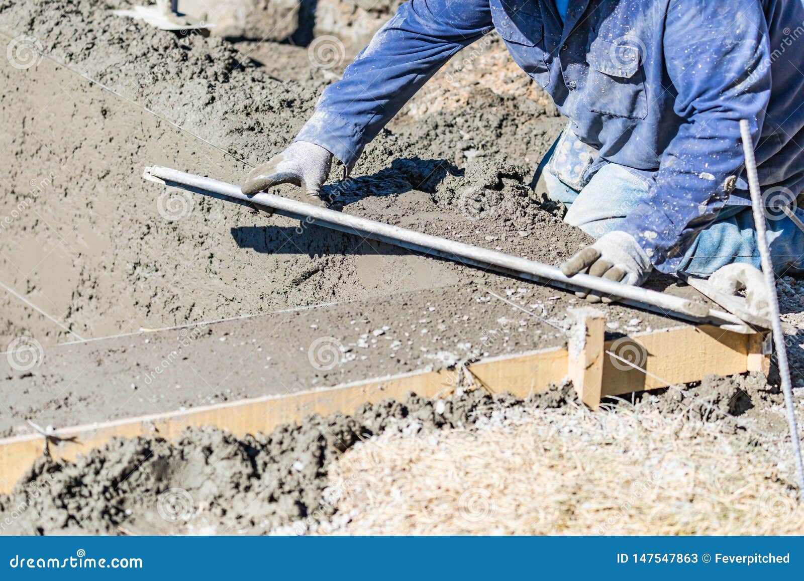 Pool Construction Worker Working with a Smoother Rod on Wet Concrete ...