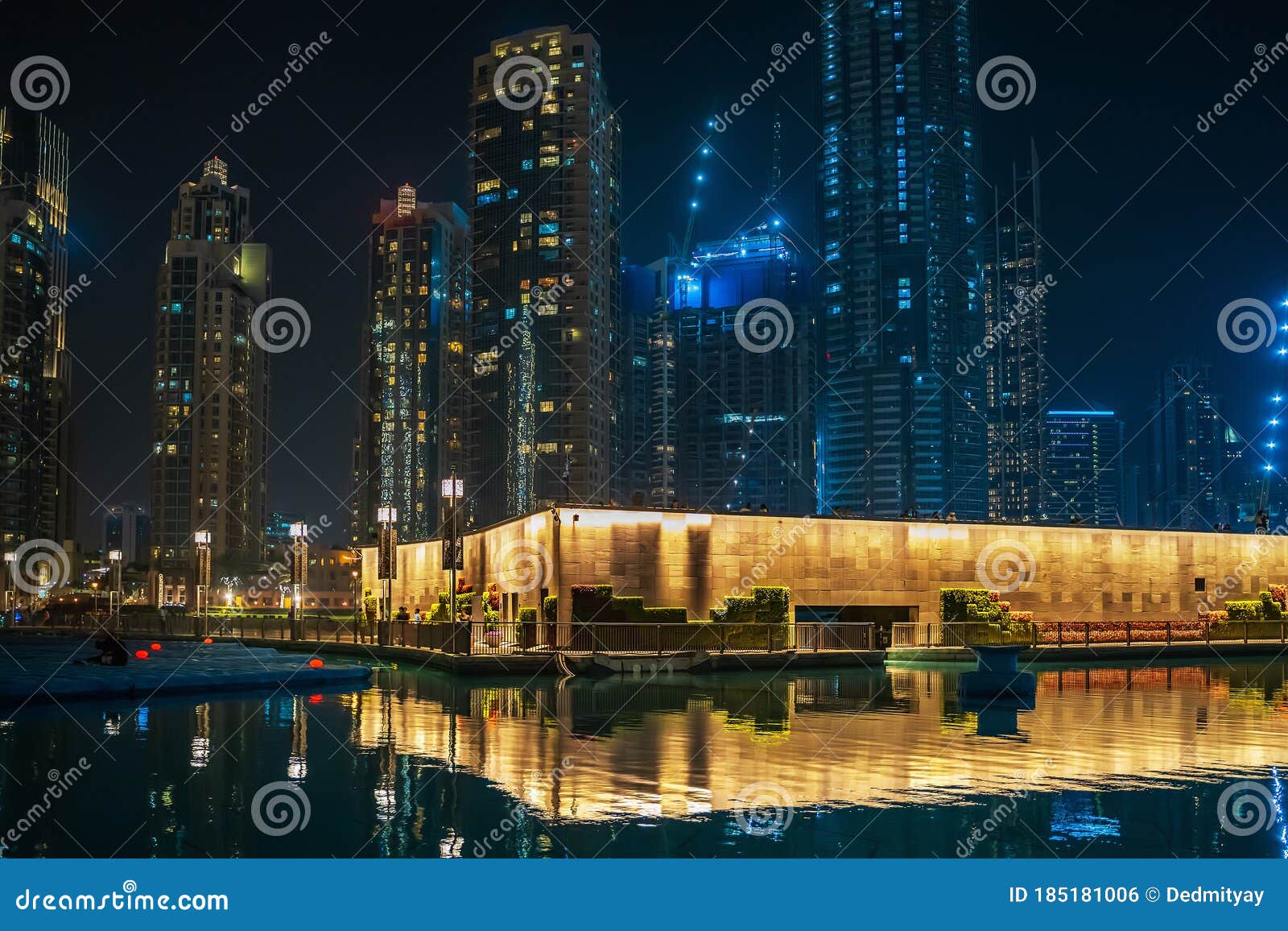 Pool with Reflection and Illuminated High Buildings at Night in Dubai ...