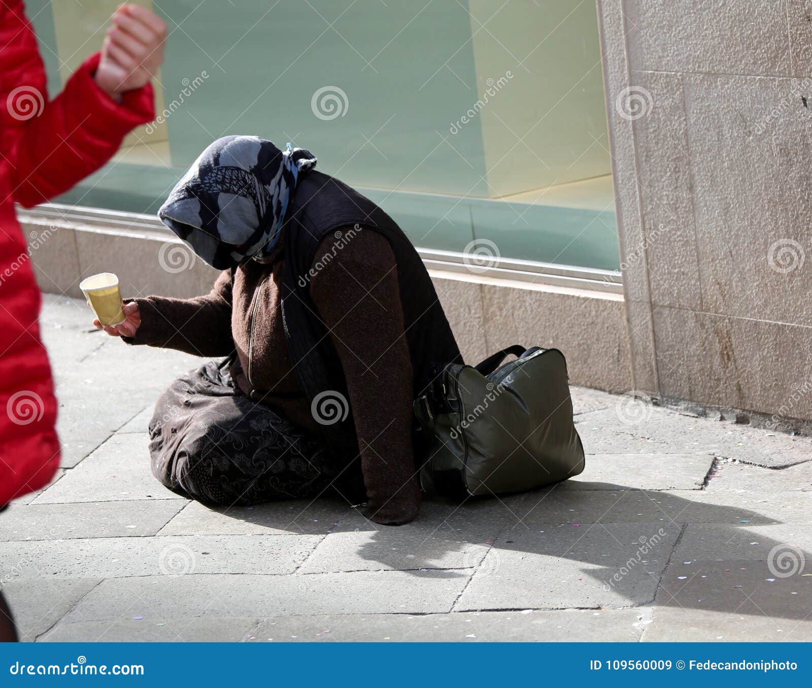 Poor Gypsy Woman Begs For Alms Lying In The Street Stock Photo ...