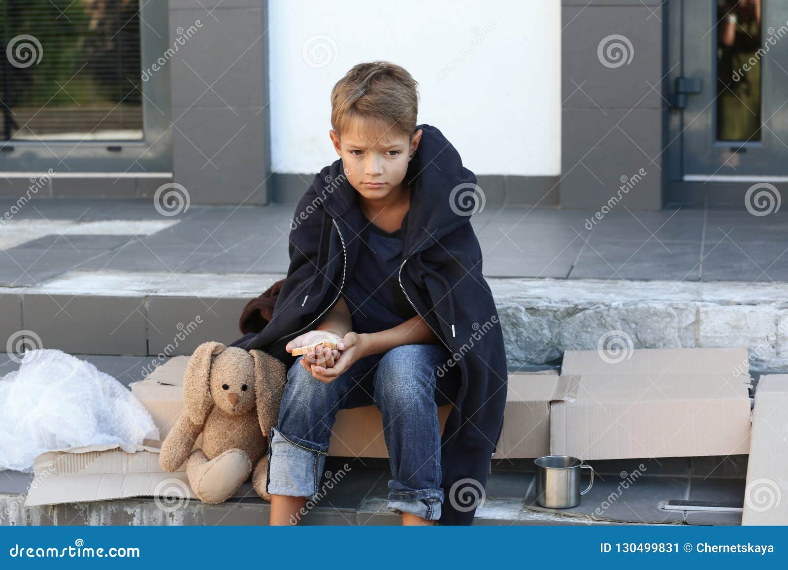 Poor little boy with bread stock image. Image of outdoors - 130499831