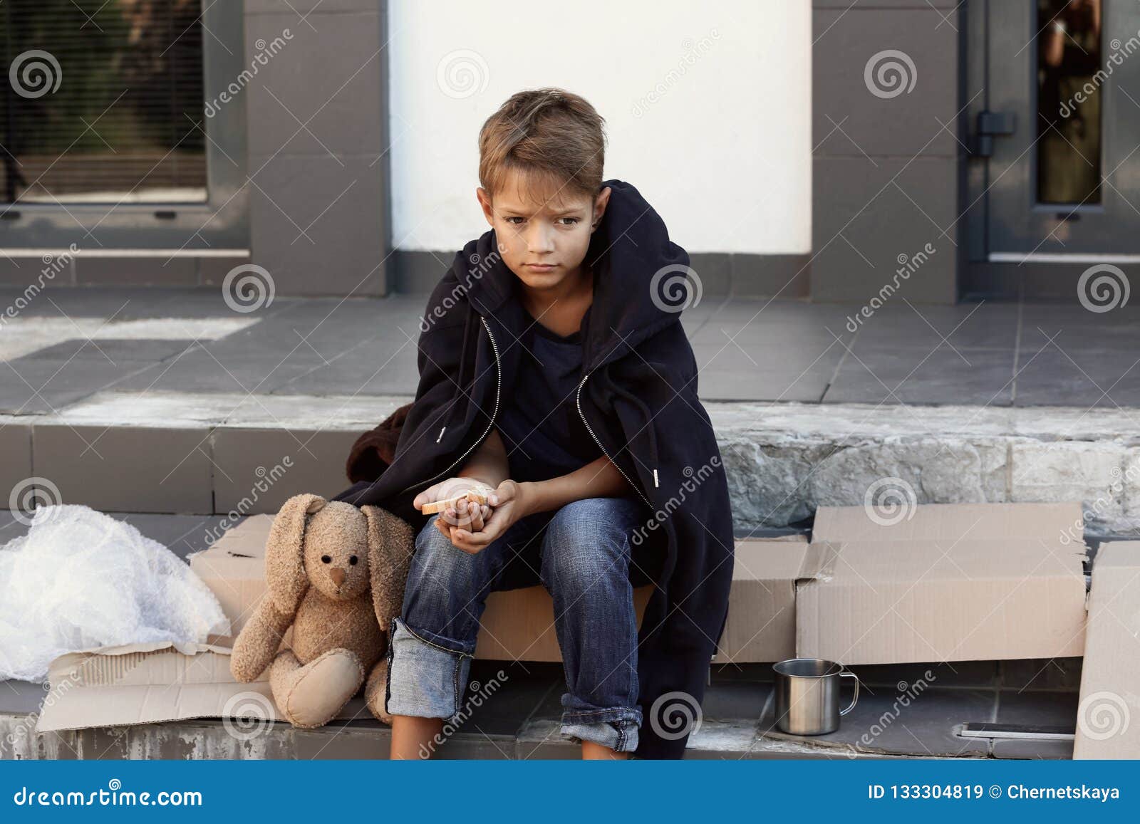 Poor little boy with bread stock image. Image of background - 133304819