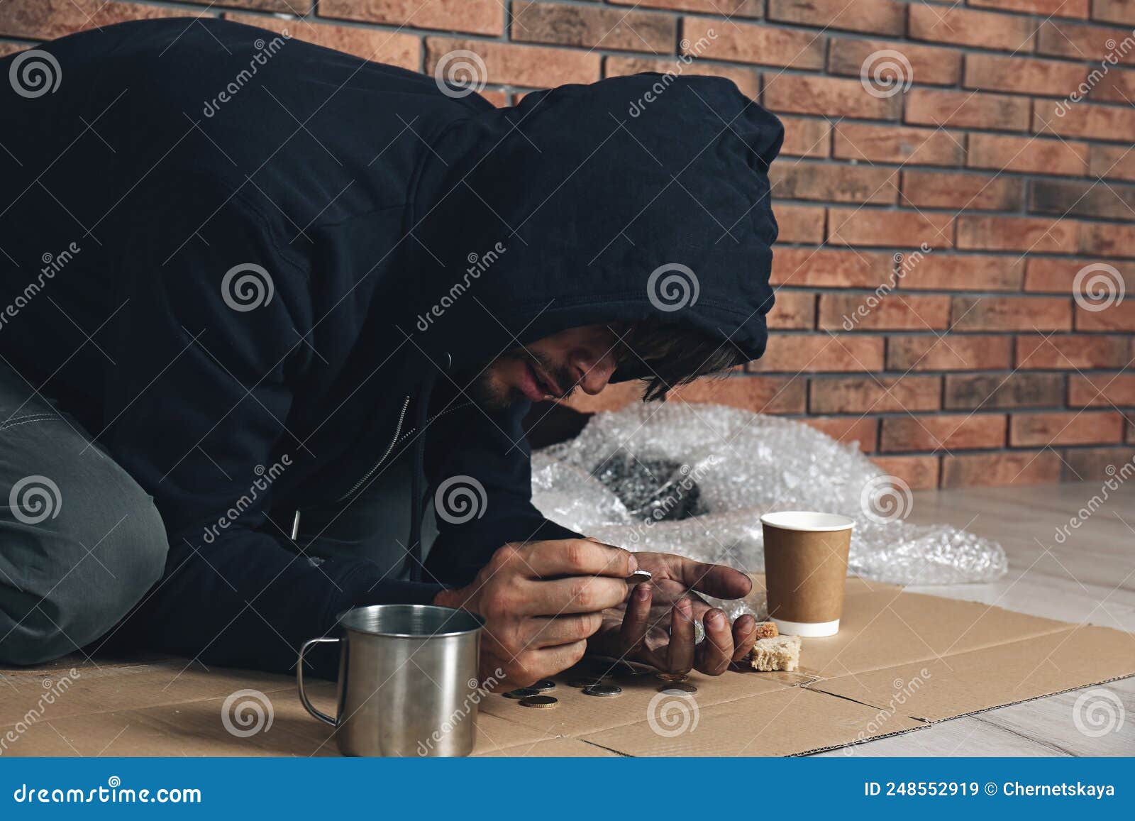 Poor Man Counting Coins on Floor Near Brick Wall Stock Image - Image of ...