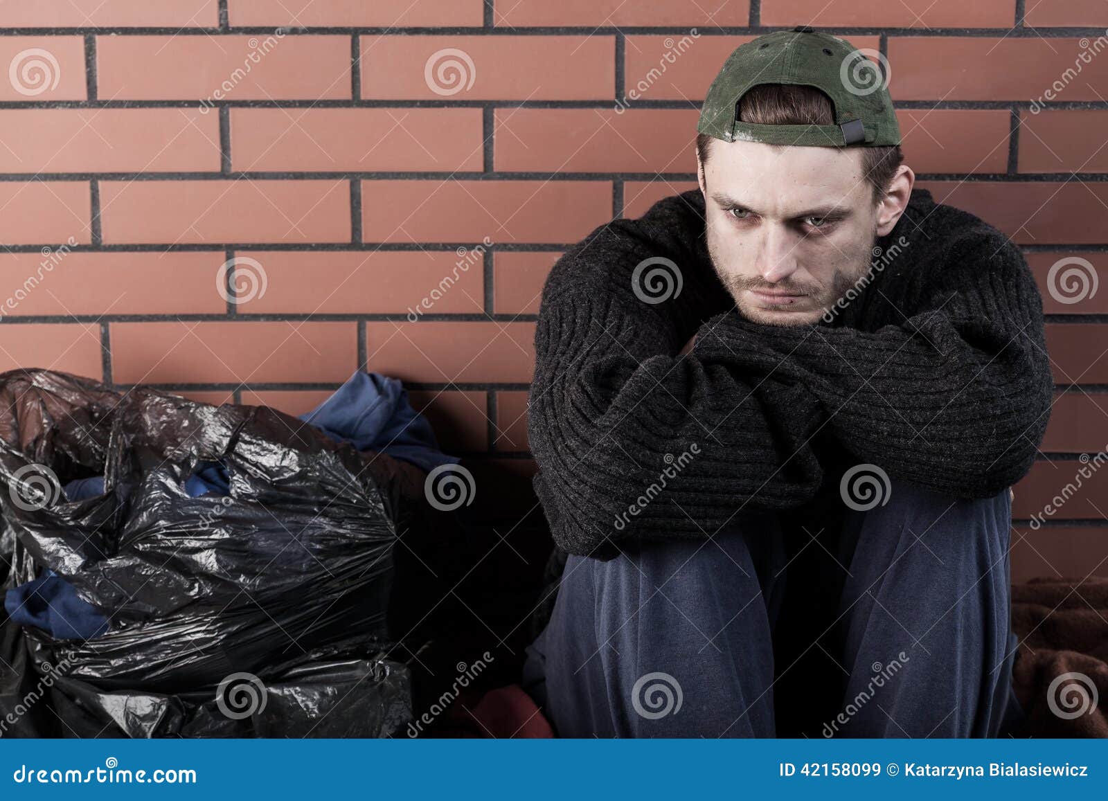 Poor Man Sitting Hunched on the Ground Stock Image - Image of ...