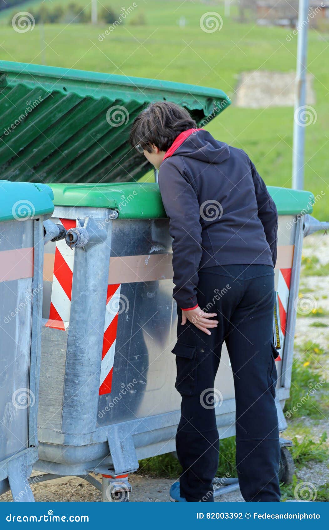 Poor Young Boy Looks into the Garbage Can Stock Photo - Image of meager ...
