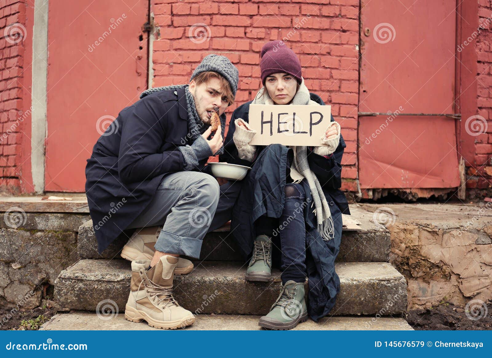Poor Young Couple with HELP Sign and Bread on Street Stock Image ...