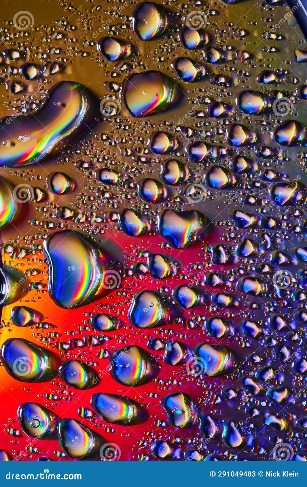 Pop of Color in Dark with Fizzy Bubbles on Reflective Silver Surface in ...