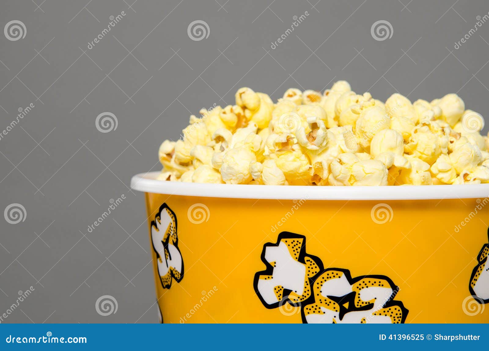 Popcorn bucket overflowing stock image. Image of movie - 41396525