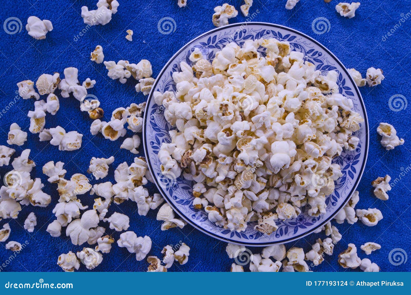 Popcorn in Dish and on Blue Clothes Floor Stock Photo - Image of ...