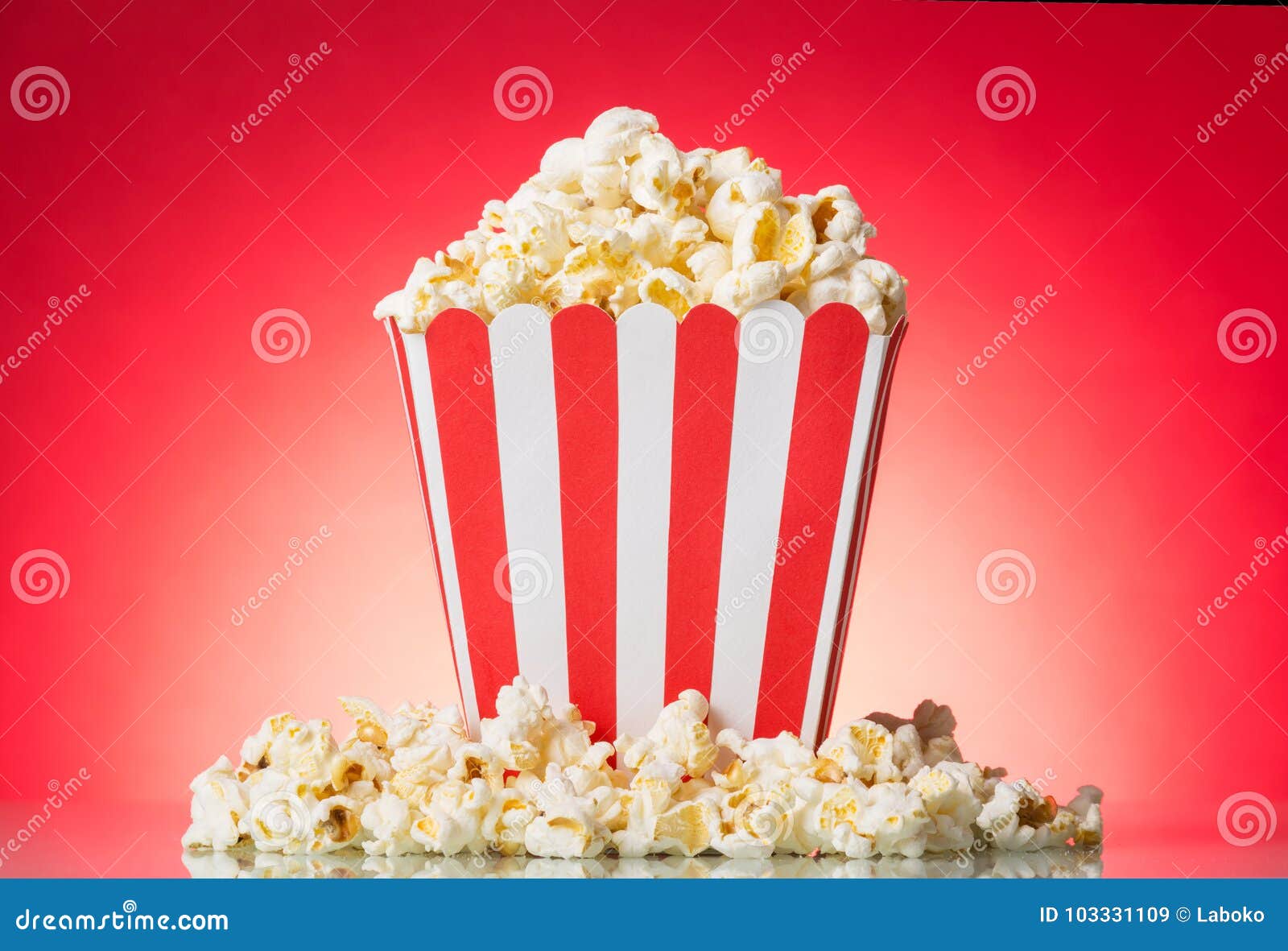 Popcorn in Large Square Box and Around on Bright Red. Stock Image ...