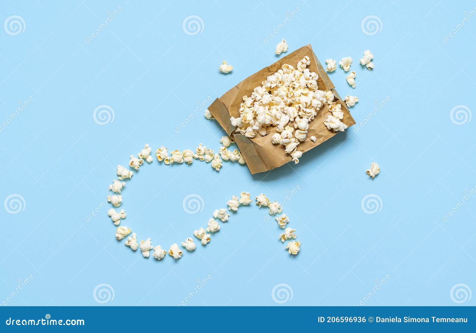 Popcorn in a Paper Bag Isolated on Blue Background. Popcorn Bag ...