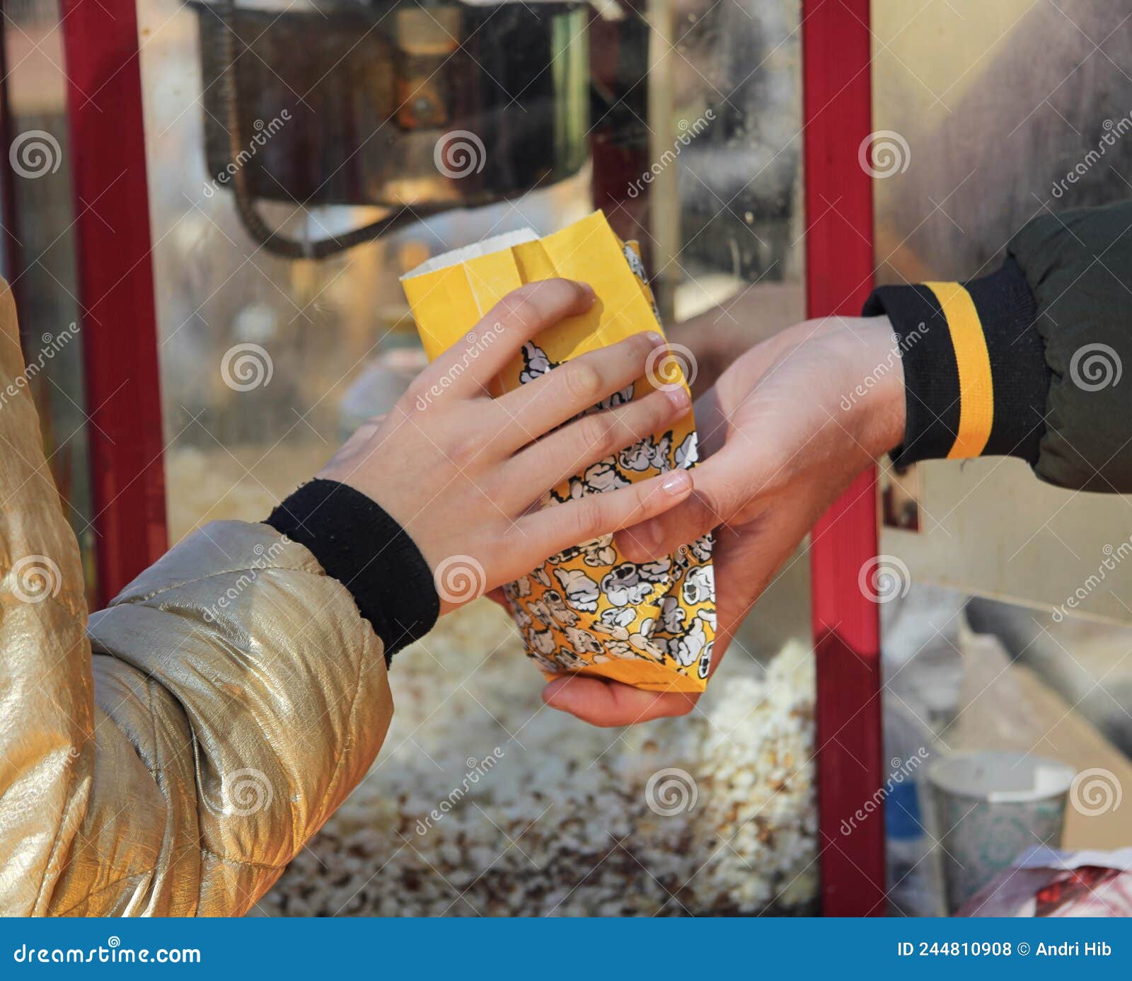 Popcorn in a Paper Pack. Hand with a Pack of Popcorn. Stock Photo ...