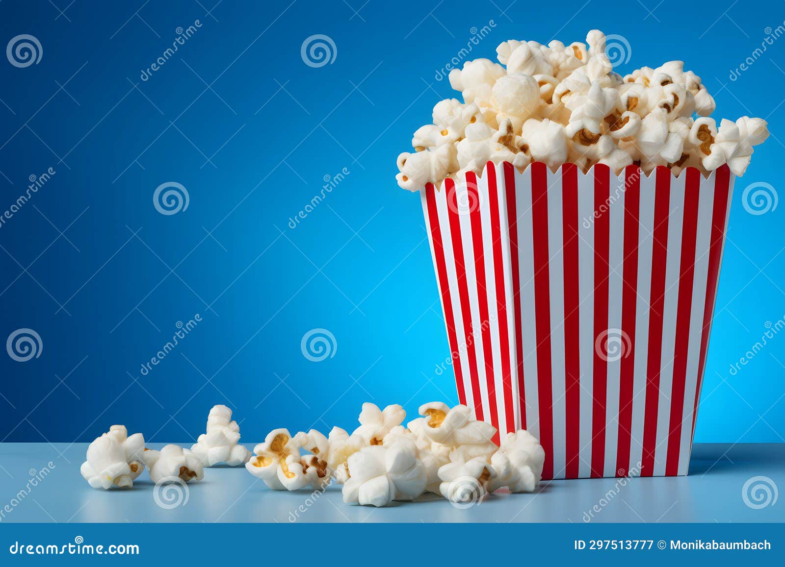 Popcorn in Red and White Striped Back in Front of Blue Background with ...