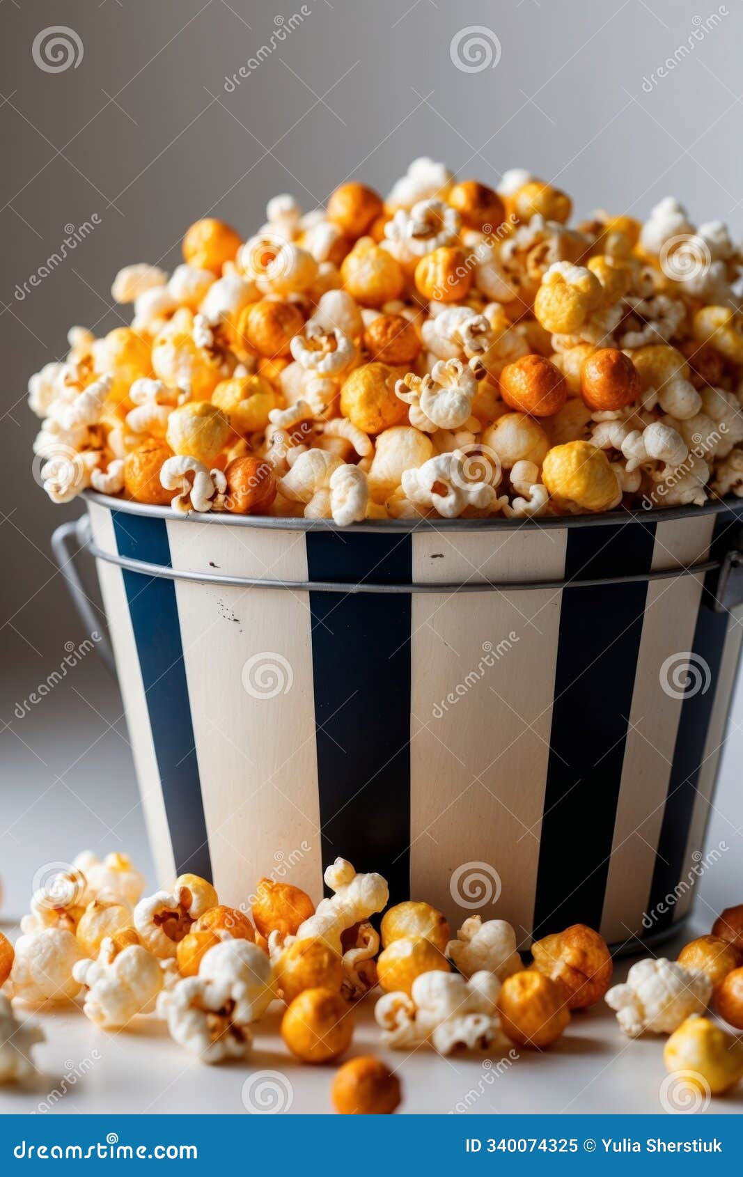Popcorn is Spilling Out of a Striped Bucket. Stock Image - Image of ...