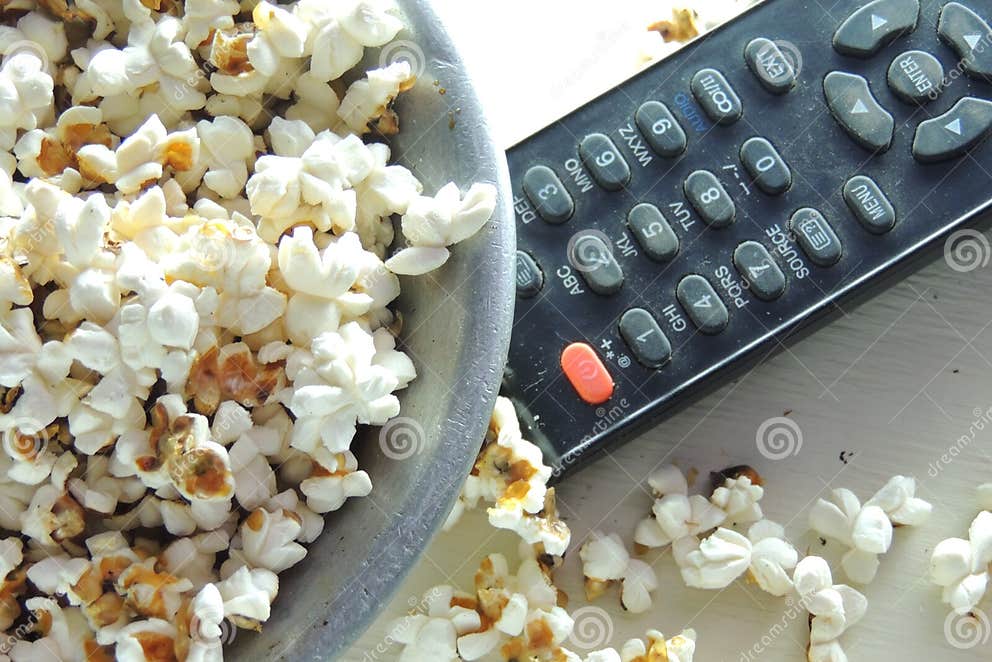 Popcorn and the TV remote stock photo. Image of bowl - 80015196